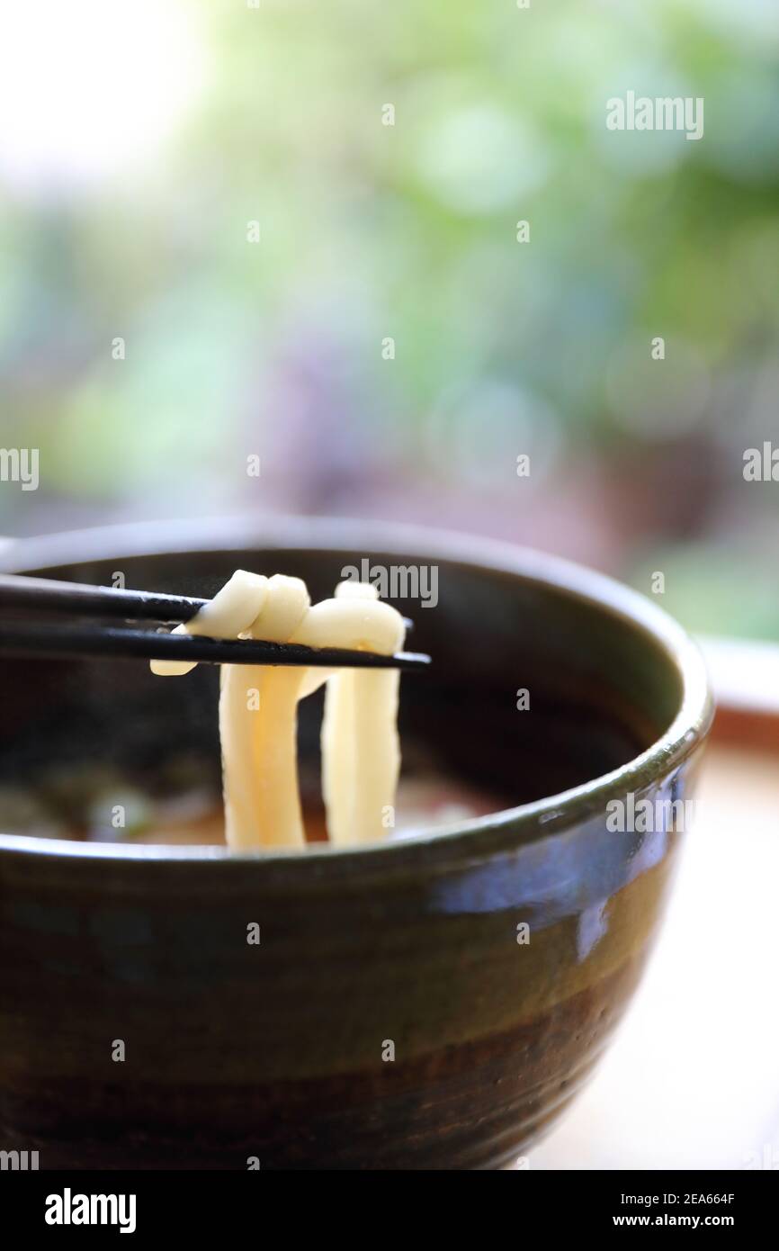 kitsune udon noodles with fish ball and tofu on wood background ...