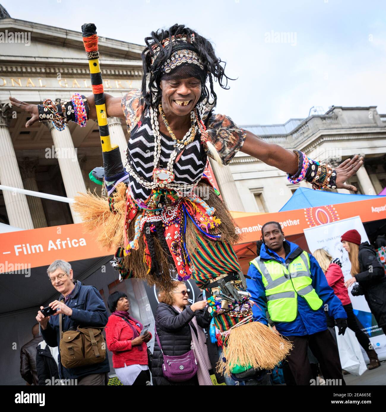African stilt performer. Dance groups in colourful costumes perform at ...