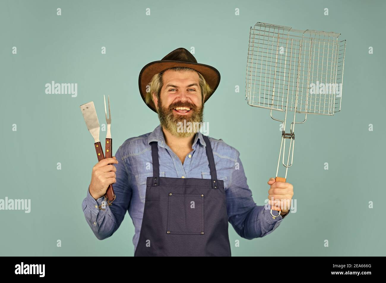 Medium rare. Tools roasting meat. Man in apron hold barbecue grill ...