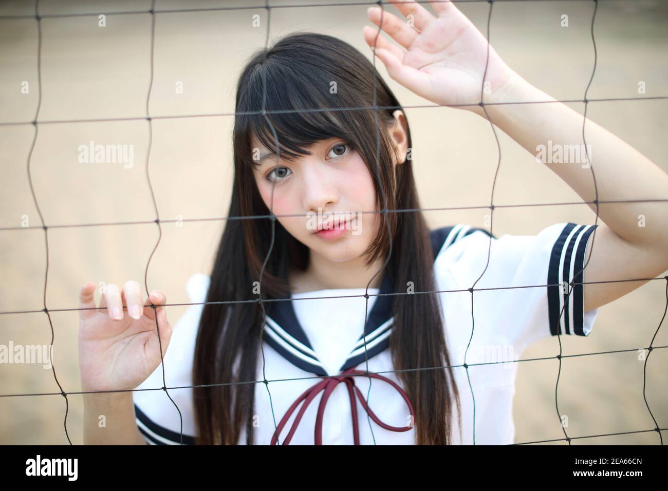 Portrait of beautiful Asian japanese high school girl uniform looking with net Stock Photo - Alamy
