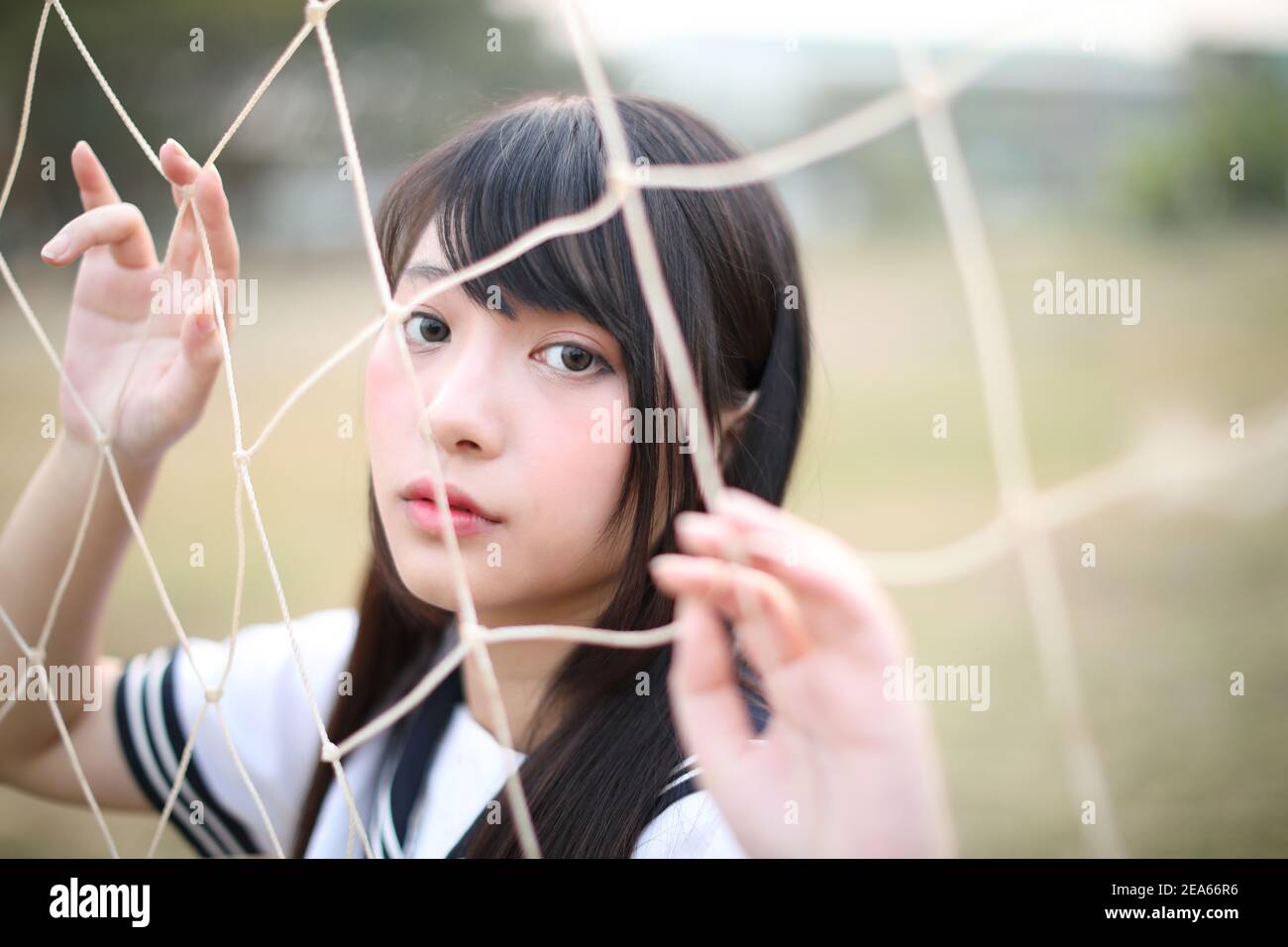 Portrait of beautiful Asian japanese high school girl uniform looking with net Stock Photo - Alamy