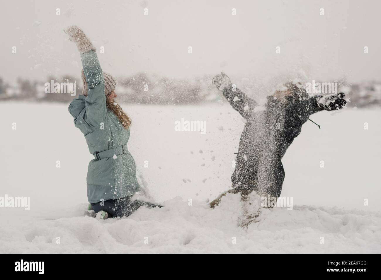 Couple enjoying snowball fight in hi-res stock photography and images ...