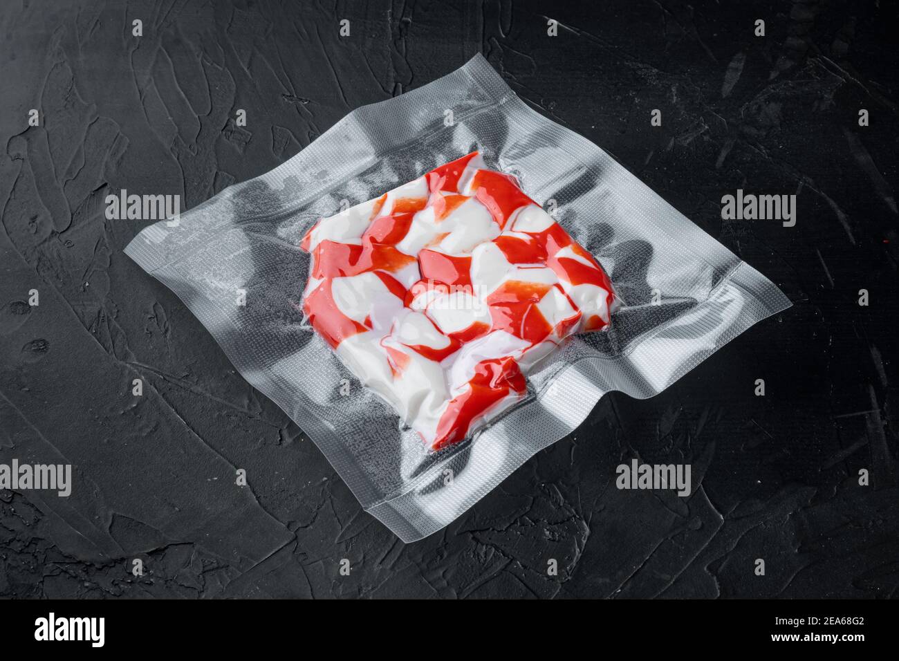 Crab meat surimi vacuum pack set, on black background Stock Photo - Alamy