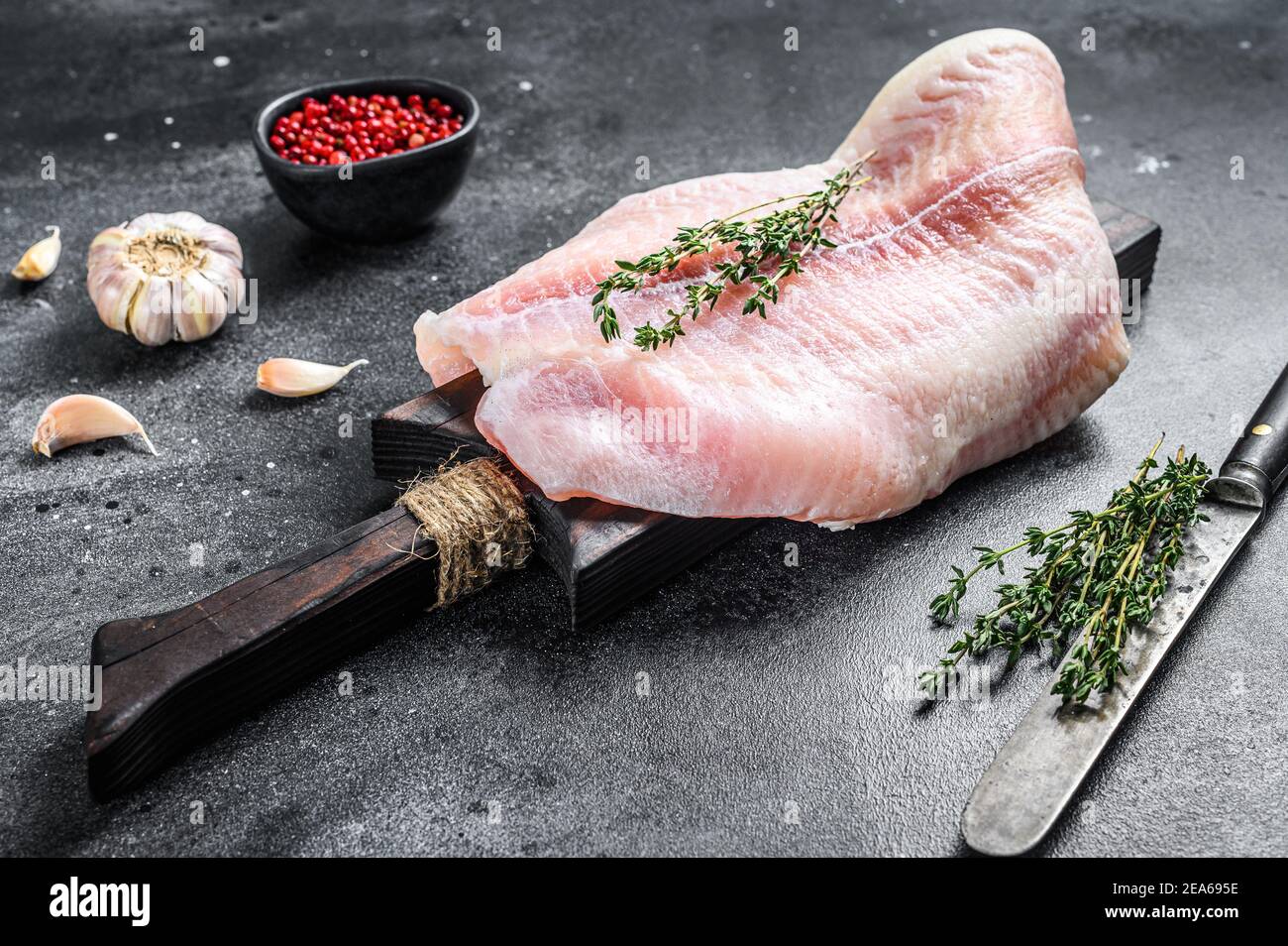 Fresh raw white fish fillet Pangasius with spices. Black background ...