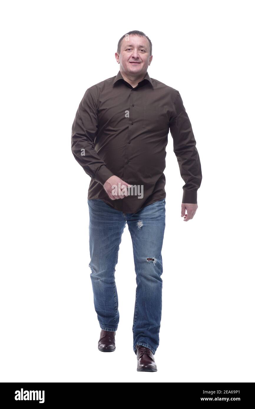in full growth. satisfied casual man striding forward Stock Photo - Alamy