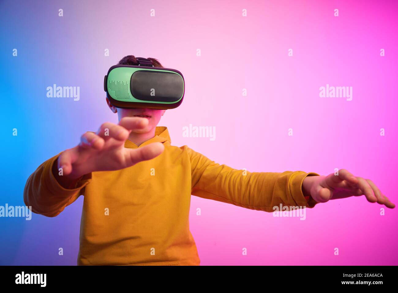 Boy with virtual reality glasses on the colorful background. Future ...