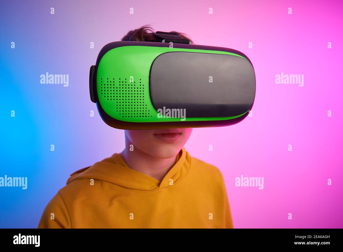 Boy with virtual reality glasses on the colorful background. Future ...