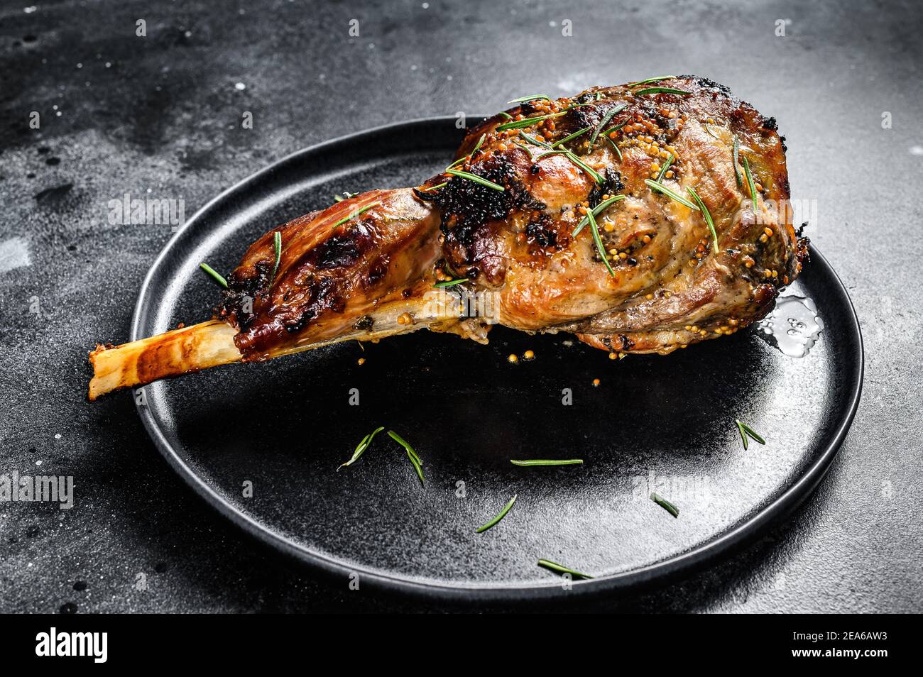 Oven baked lamb leg. Dark background. Top view Stock Photo - Alamy