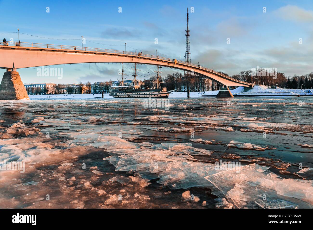 Pedestrian bridge over the Volkhov River. Winter view of a frozen river ...