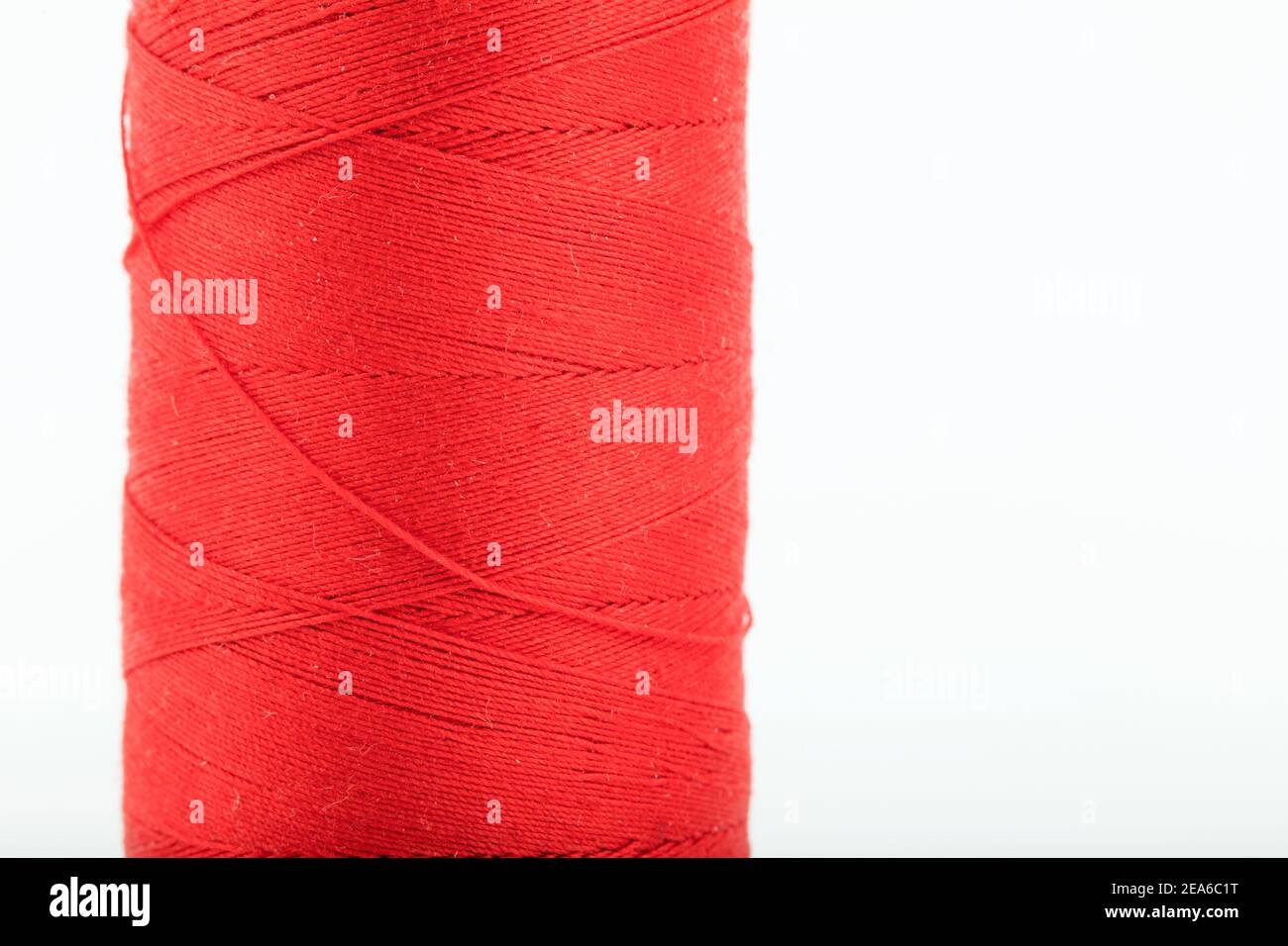 Red colored Spools of Thread on white background Stock Photo - Alamy