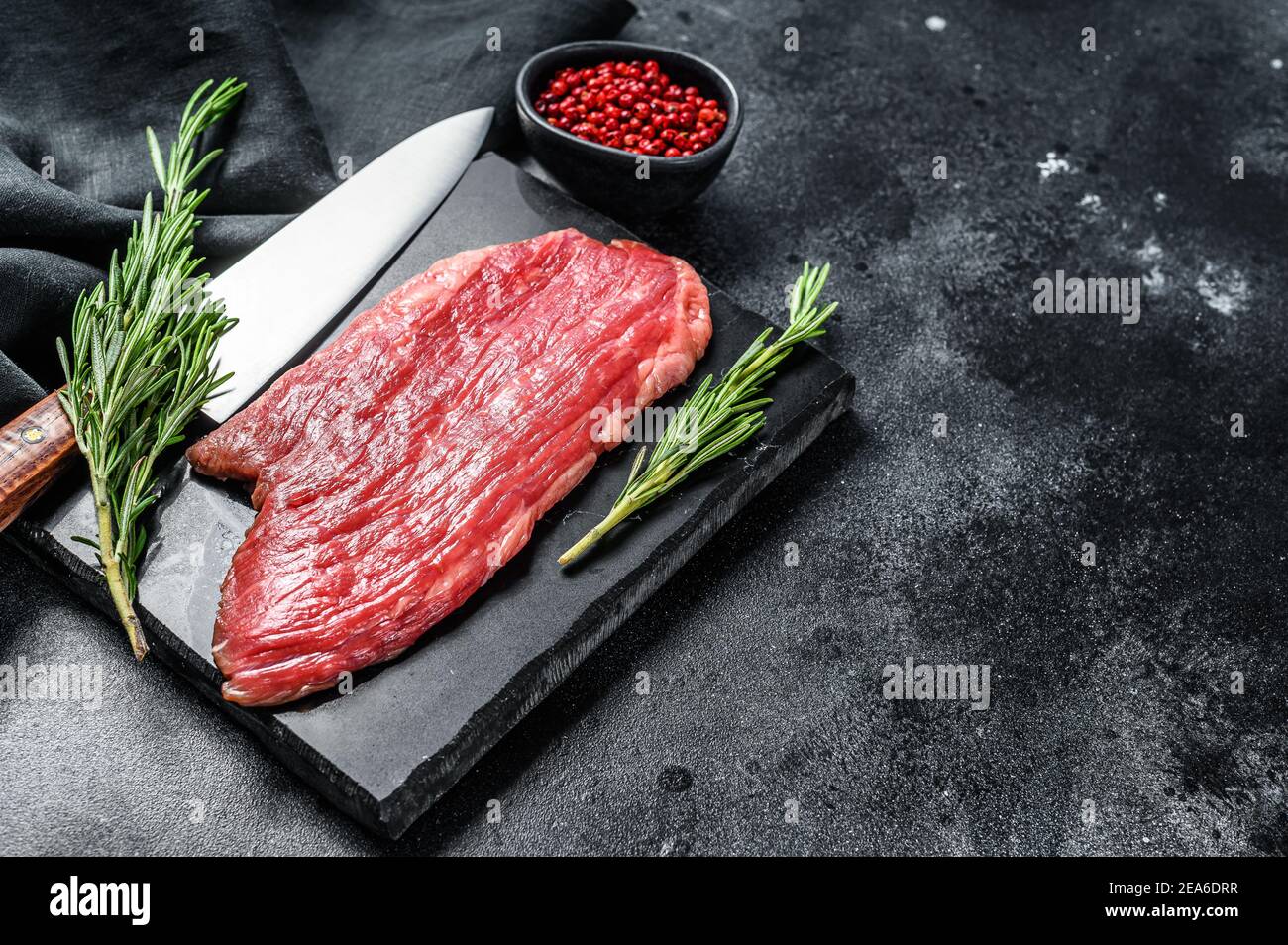 Flank steak. Raw Marble beef meat black Angus. Black background. Top ...