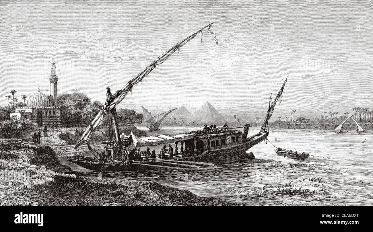 Felucca sailboats on River Nile and the pyramids of Giza in the ...