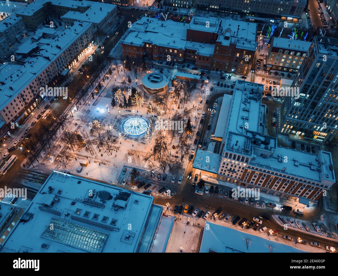 Aerial drone view of an evening city in winter with streets and ...