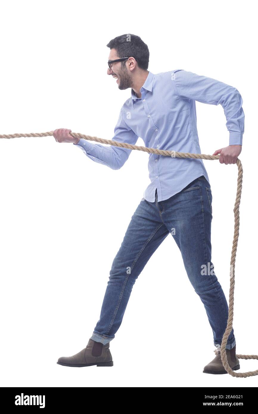 purposeful young man pulls the rope. isolated on a white background ...