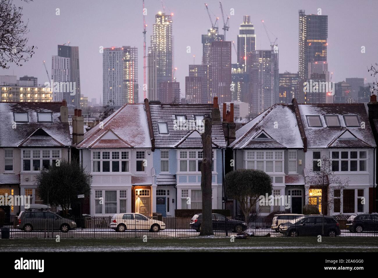 Snow-covered roofs and the glowing lights in the porches of south ...