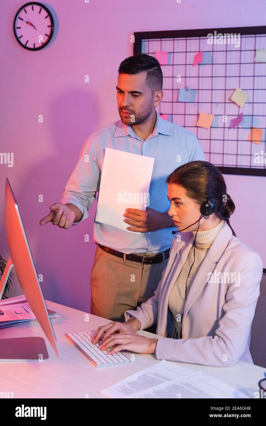 Business people pointing at monitor hi-res stock photography and images ...