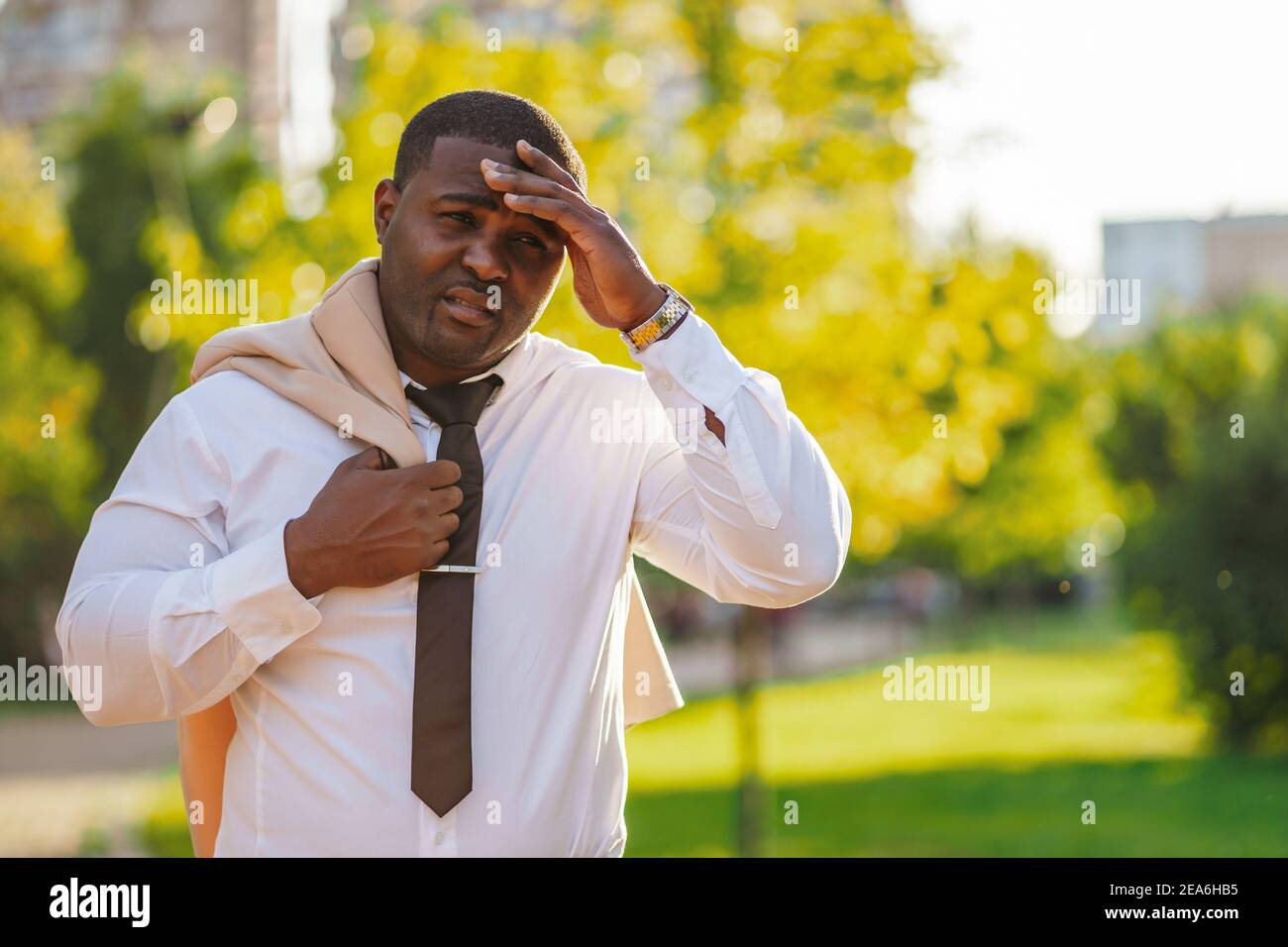 Portrait of tired african-american businessman who is going home from ...