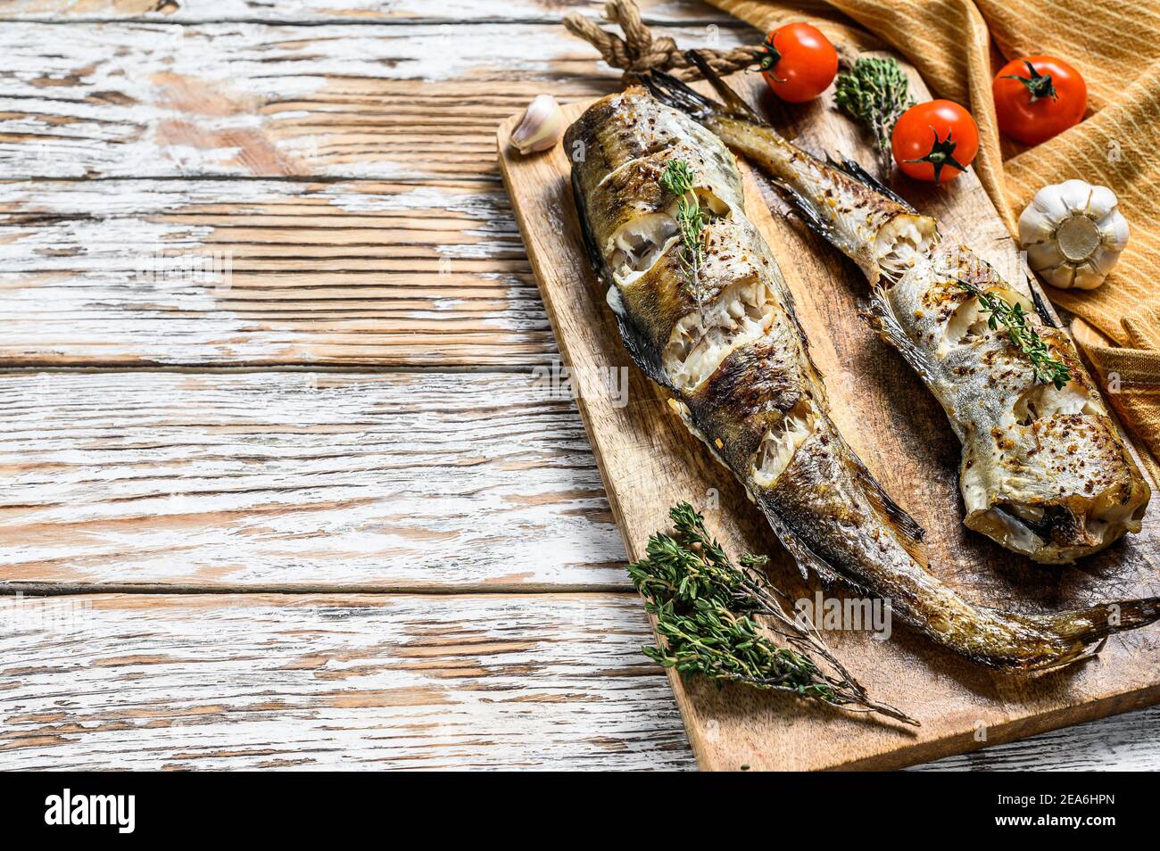 Oven baked pollock cooked in a savory marinade. White background. Top ...