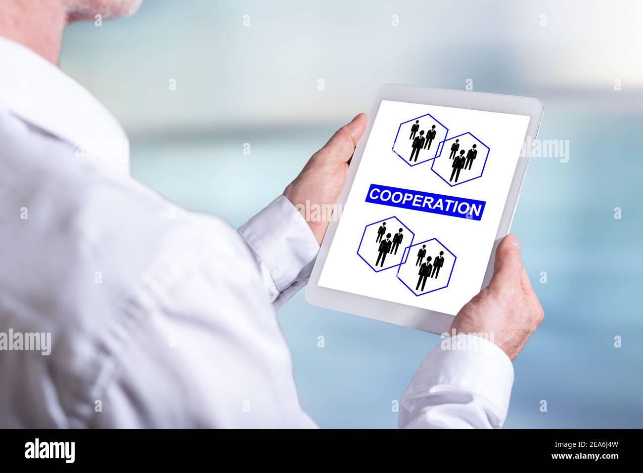 Tablet screen displaying a cooperation concept Stock Photo - Alamy