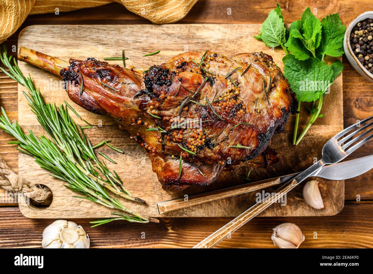 Roasted goat leg with herbs. Farm meat. Wooden background. Top view ...