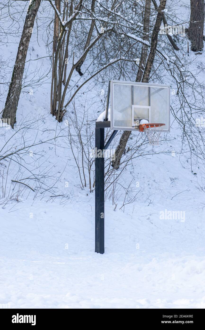Recreation concept. Basketball board covered with snow standing in ...