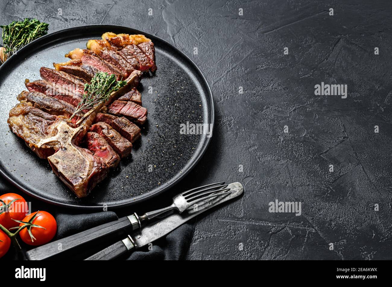 Grilled Porterhouse steak on a plate. Cooked beef meat. White wooden ...