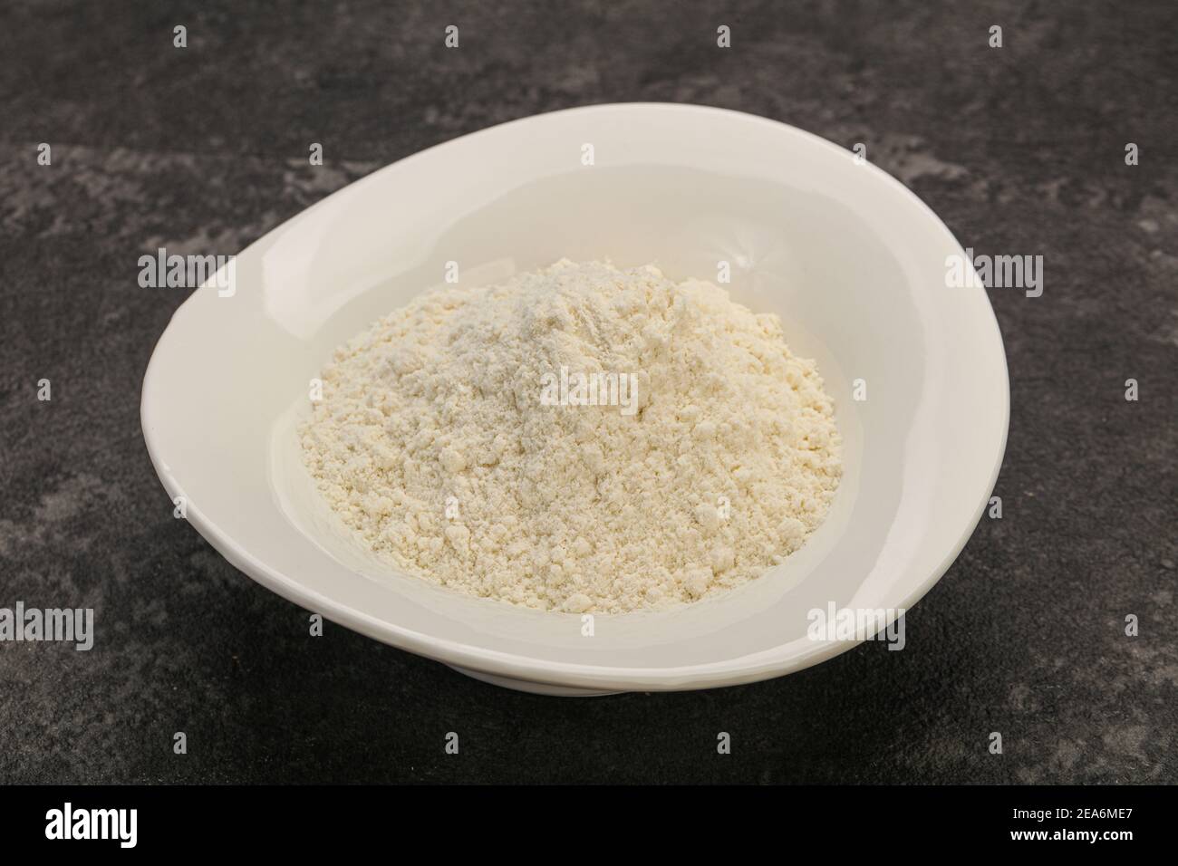Wheat flour heap in the bowl for cooking Stock Photo - Alamy