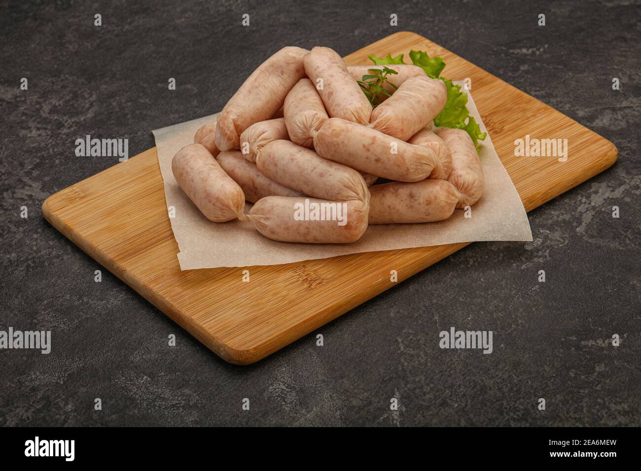 Raw natural chicken baby sausages for roast Stock Photo - Alamy