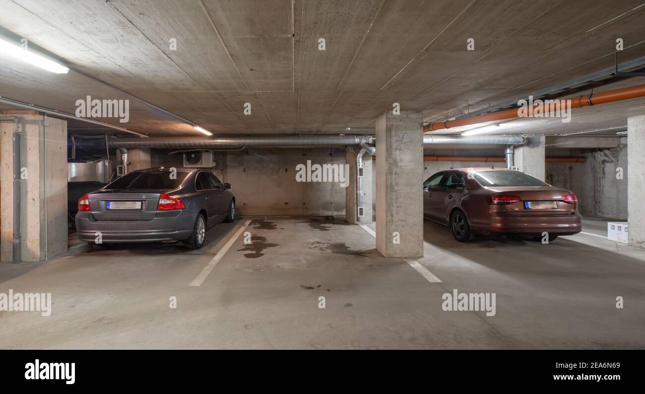 Cars on underground parking in modern residential complex Stock Photo ...
