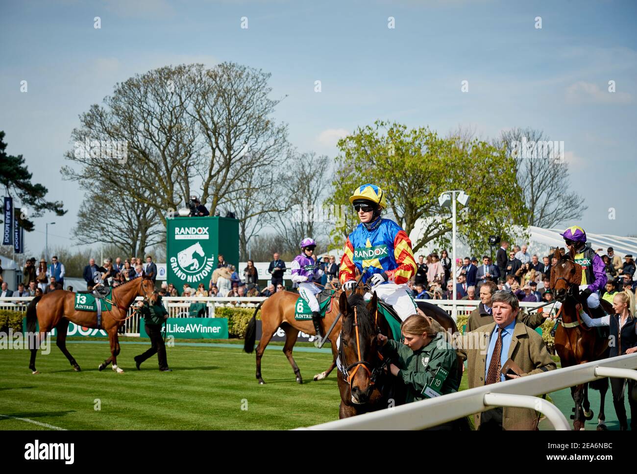 Jockeys at The Grand National making their way around the parade ring ...