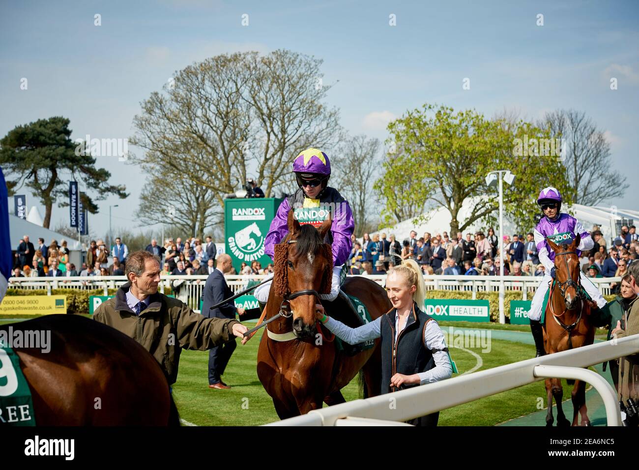 Jockeys at The Grand National making their way around the parade ring ...