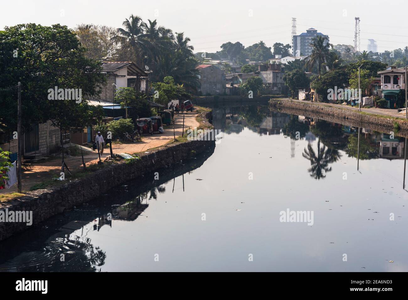 Slums next to train tracks at the poluted river of Kelani in Colombo ...