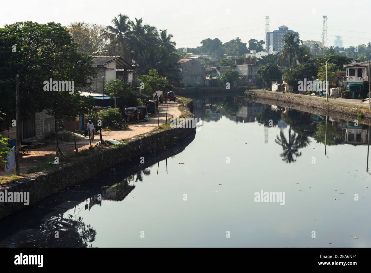 Slums next to train tracks at the poluted river of Kelani in Colombo ...
