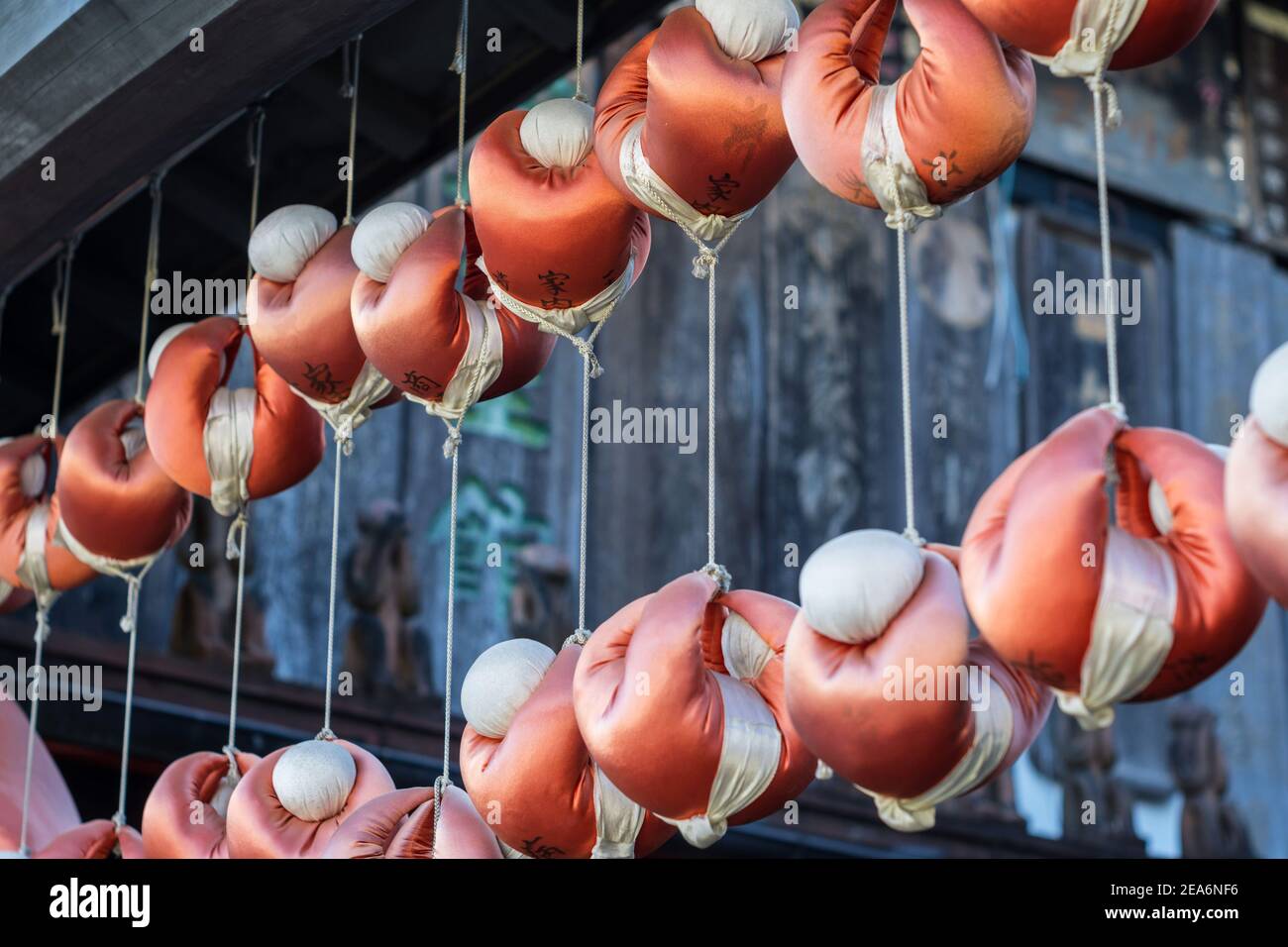 Red and white silk migawarisaru or scapegoat monkeys hanging outside ...