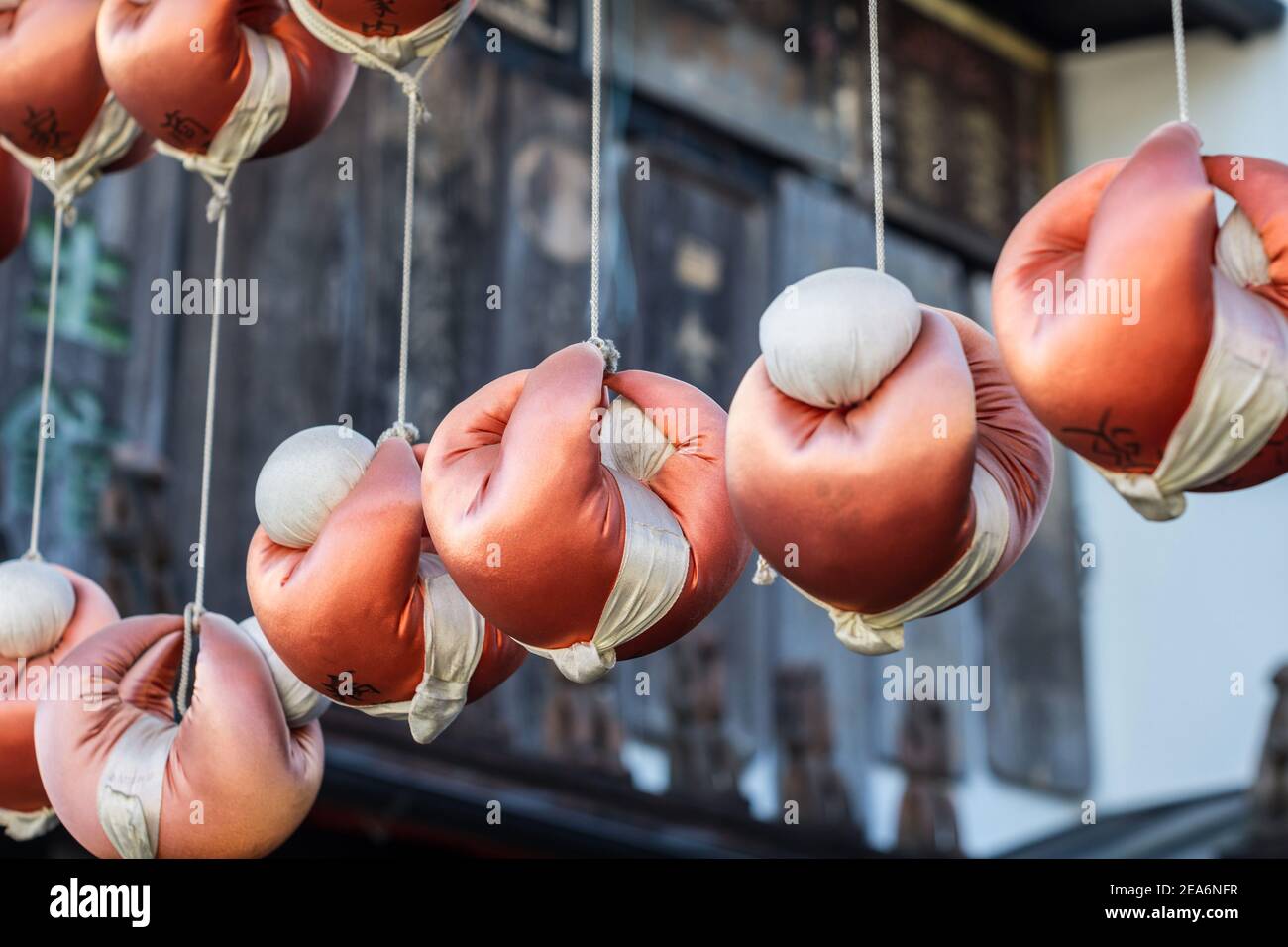 Red and white silk migawarisaru or scapegoat monkeys hanging outside ...