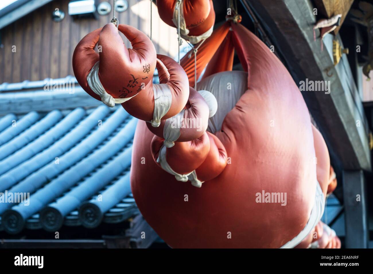 Red and white silk migawarisaru or scapegoat monkeys hanging outside ...