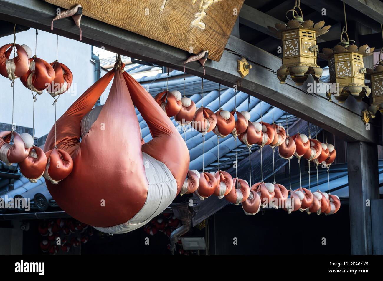 Red and white silk migawarisaru or scapegoat monkeys hanging outside ...