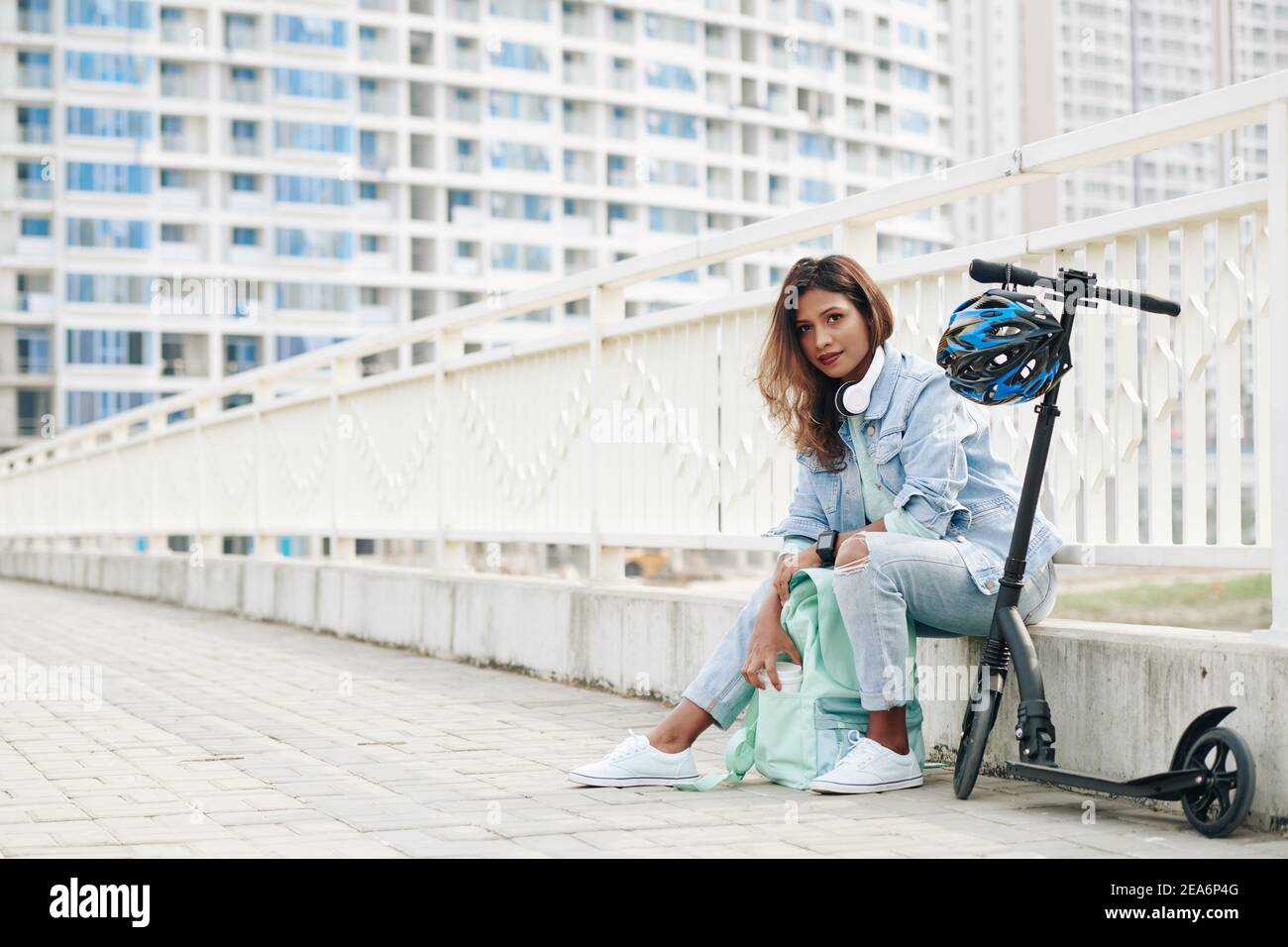 Young woman sitting on curb hi-res stock photography and images - Alamy