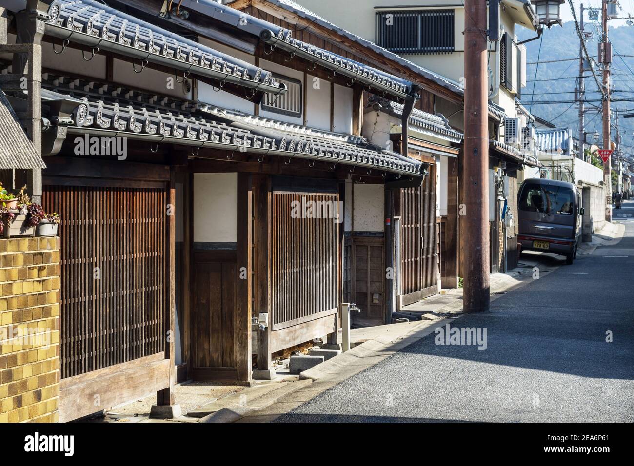 A traditional wooden Japanese house with a lattice front on a back ...