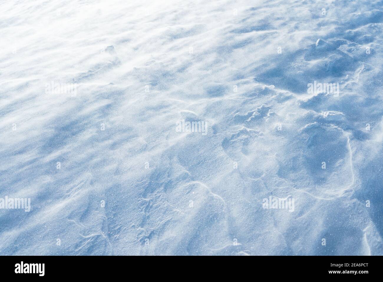 Blowing snow over snowy surface on top of mountain in Switzerland ...