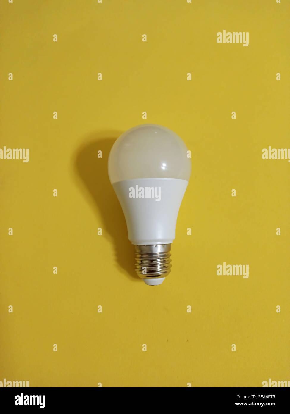 a modern eco white led electric bulb on a yellow background Stock Photo ...