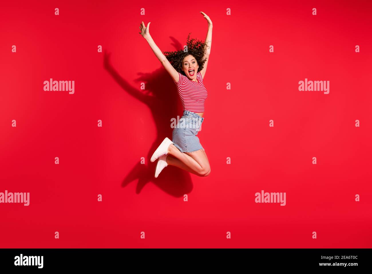 Full body photo of excited happy young girl jump up trampoline hands up ...