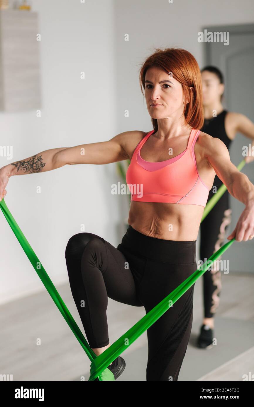 Group of young sporty attractive woman practicing pilates. People ...