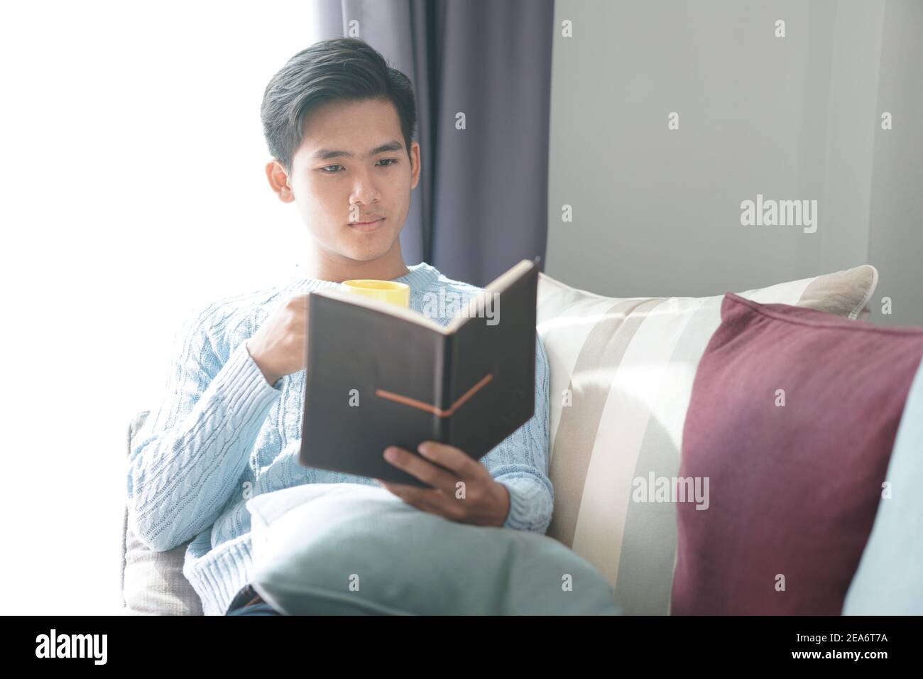 Asian man reading book hi-res stock photography and images - Alamy