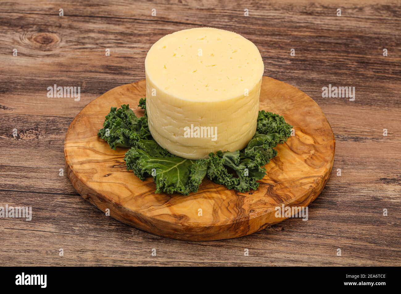 Yellow round dairy soft cheese piece Stock Photo - Alamy