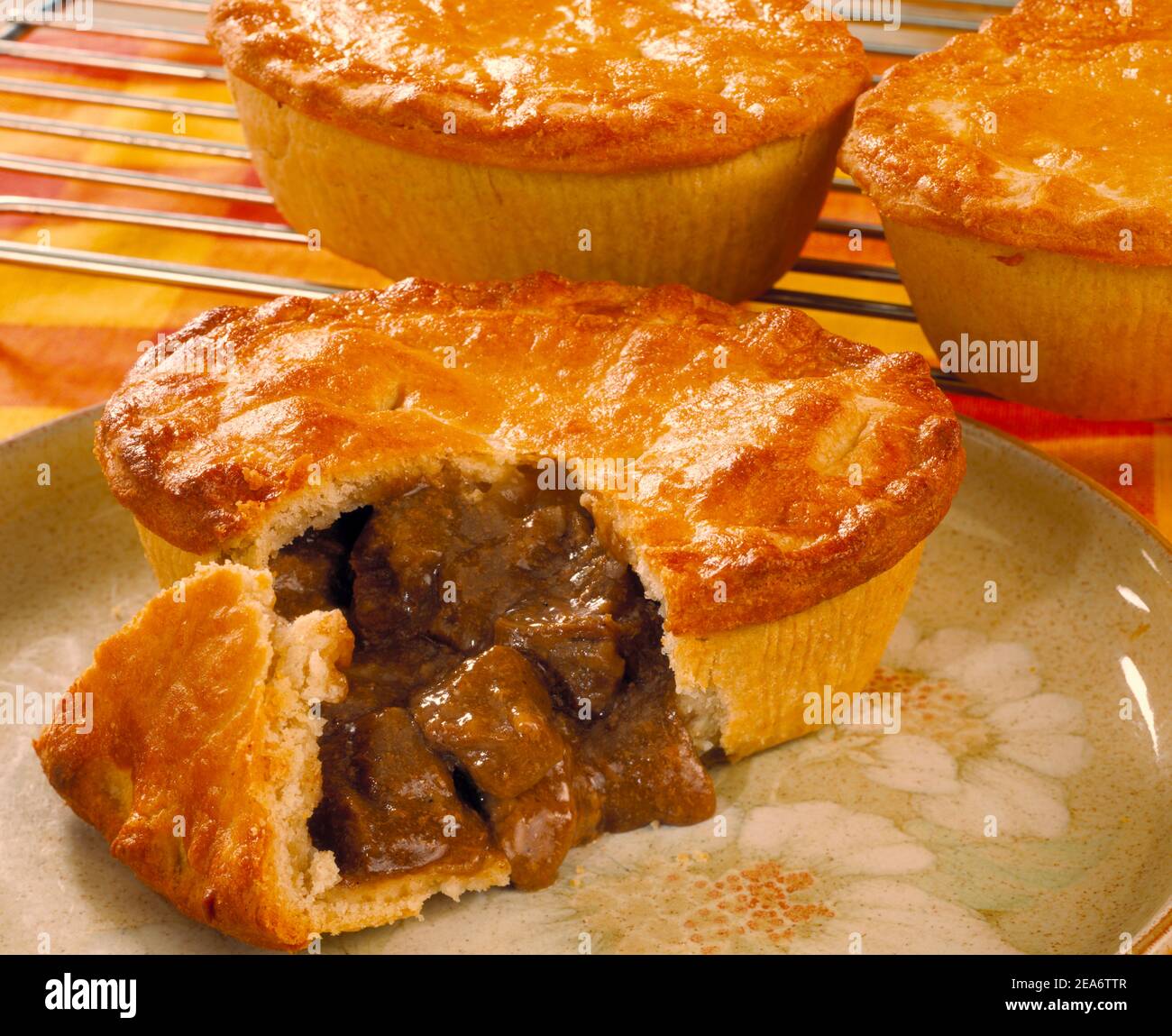 3 Steak Pies one cut open showing meat filling Stock Photo - Alamy