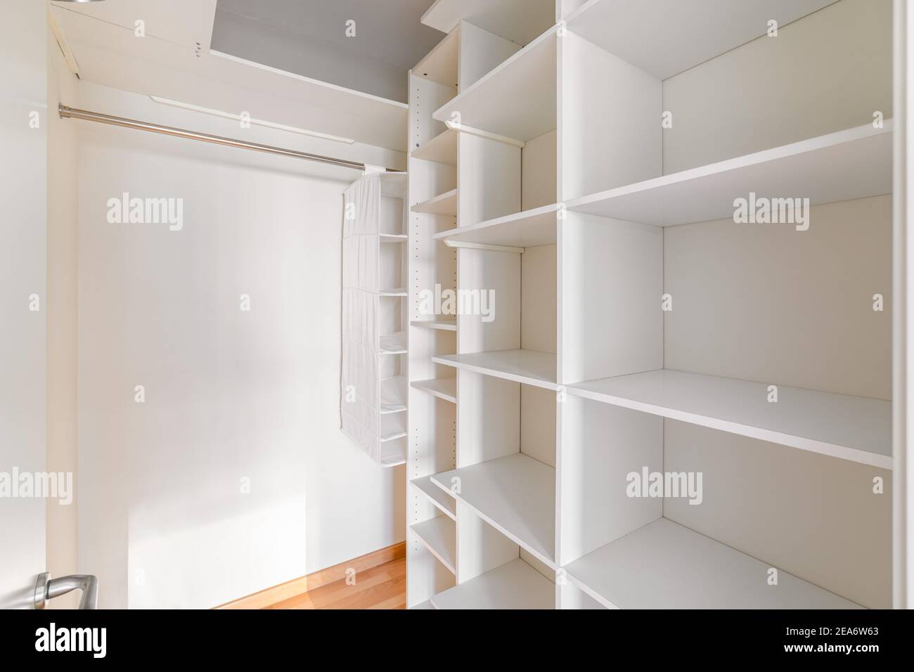 Interior of small, white and empty dressing room with shelves and no ...