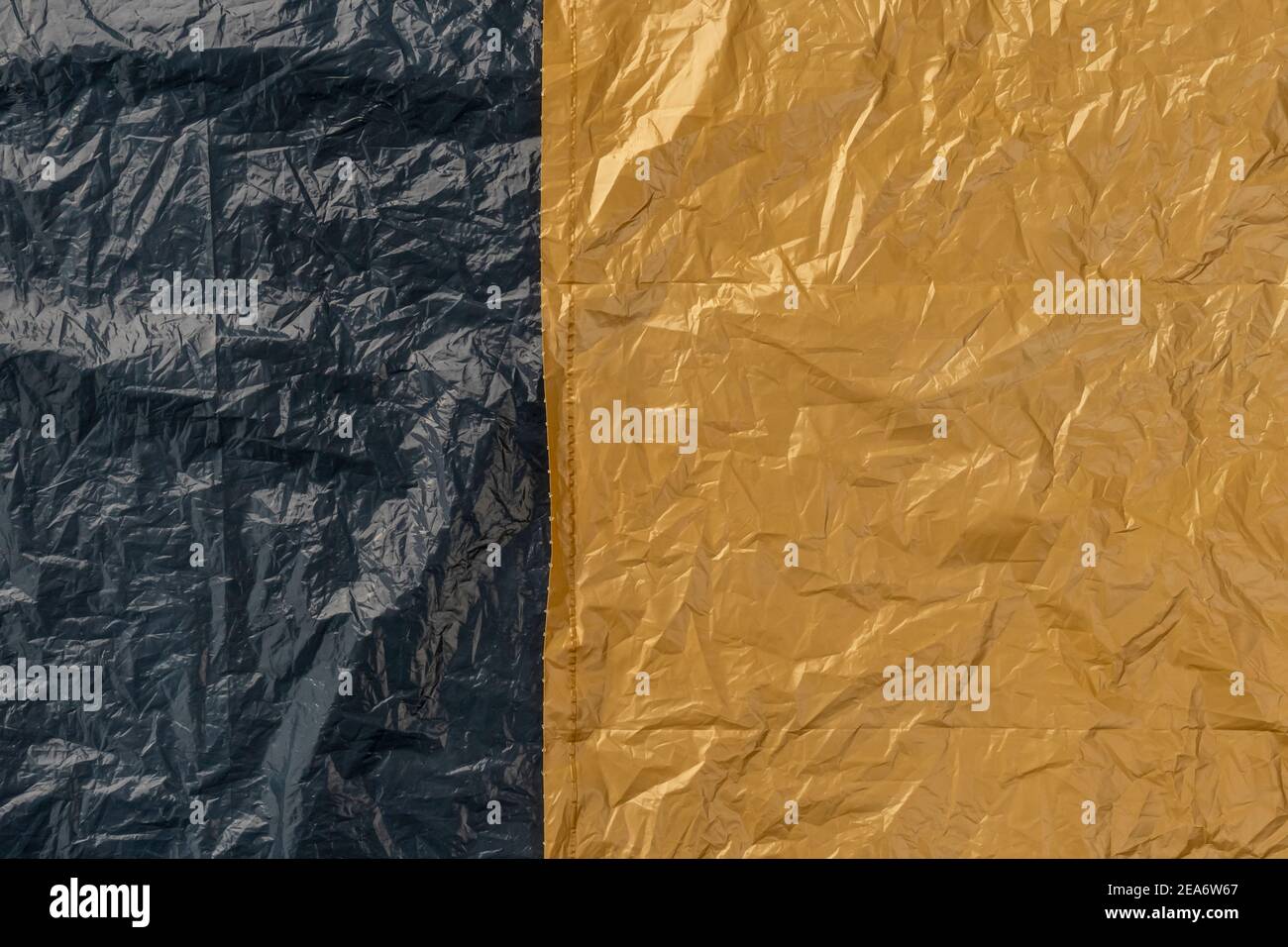 Crumpled wrinkled black beige plastic bag fragment. Abstract texture ...
