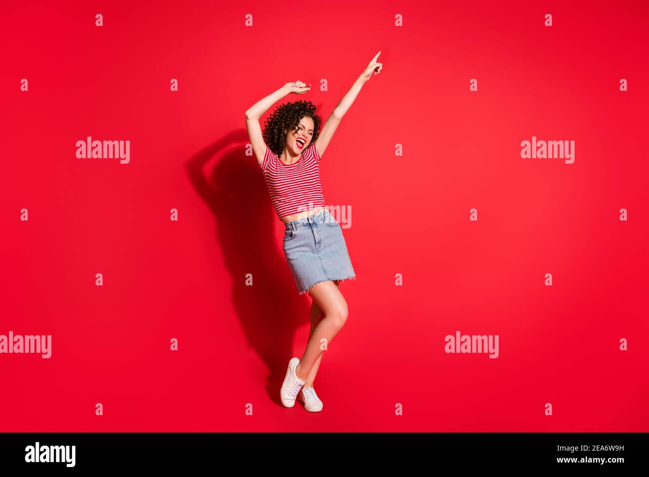 Full body photo of young positive girl enjoy point finger empty space ...