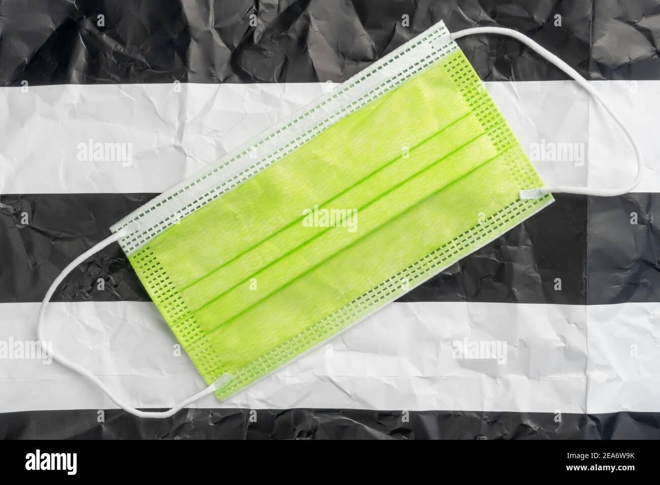 Green surgical mask with rubber ear loops. Medical hygienic mask ...